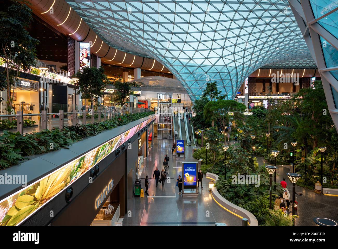 Massive glass dome and elevated walkway above indoor garden at the ...