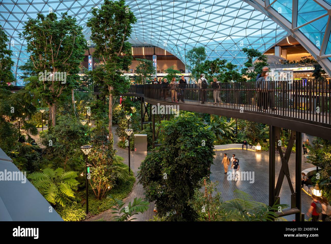 Massive glass dome and elevated walkway above indoor garden at the ...