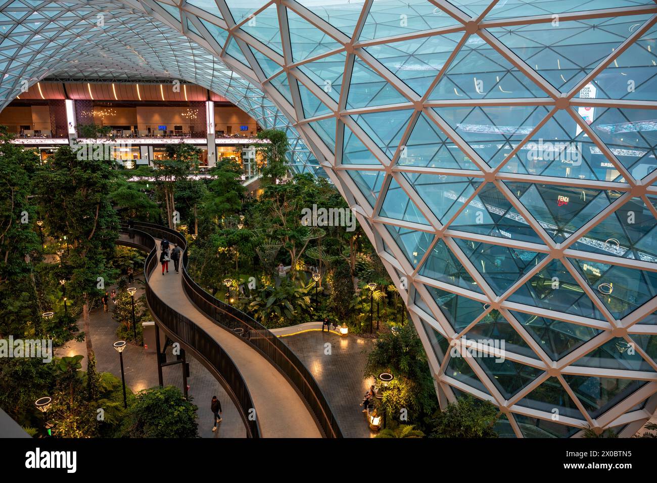 Massive glass dome and elevated walkway above indoor garden at the ...