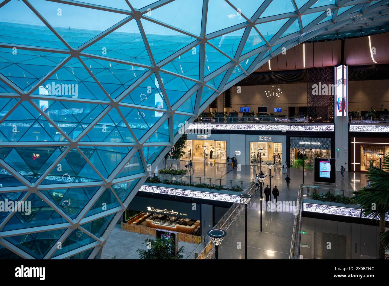 Massive glass dome and elevated walkway above indoor garden at the ...