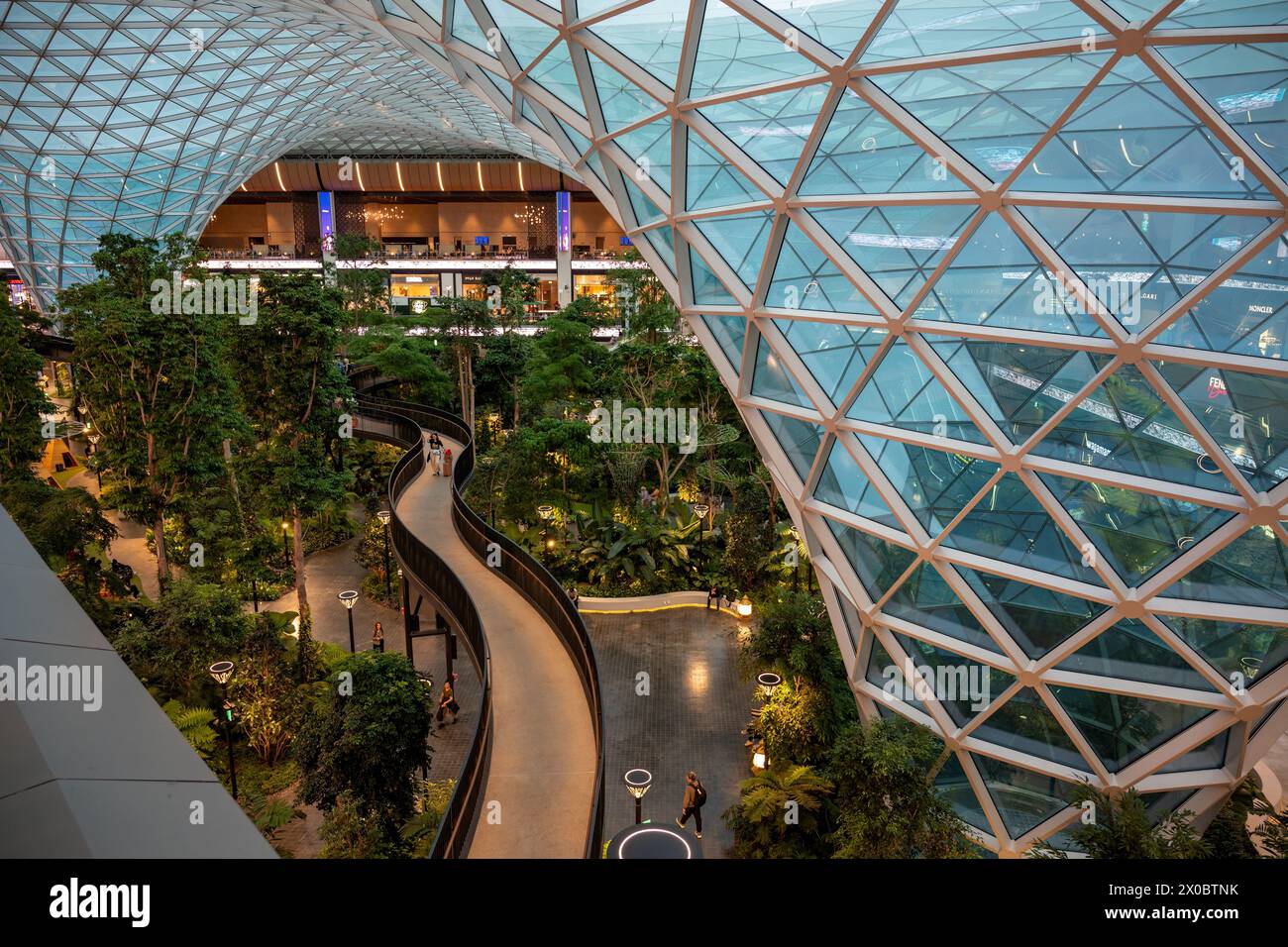 Massive glass dome and elevated walkway above indoor garden at the ...