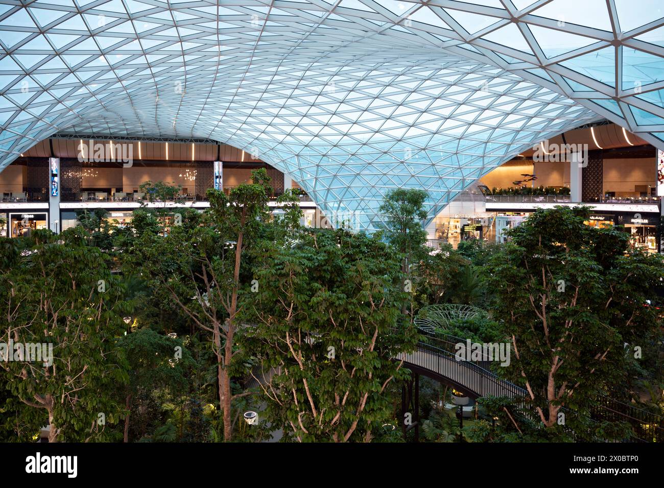 Massive glass dome and elevated walkway above indoor garden at the ...