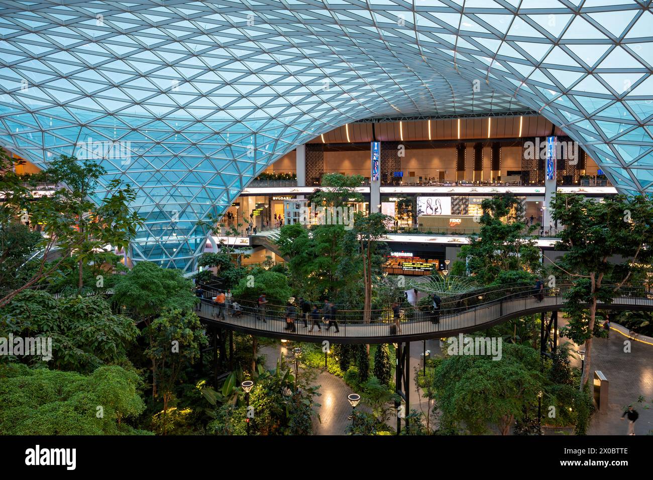 Massive glass dome and elevated walkway above indoor garden at the ...