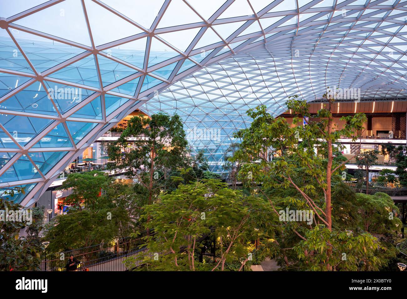 Massive glass dome and elevated walkway above indoor garden at the ...