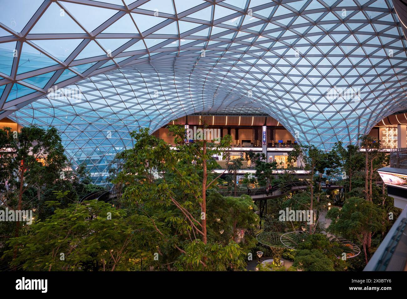 Massive glass dome and elevated walkway above indoor garden at the ...