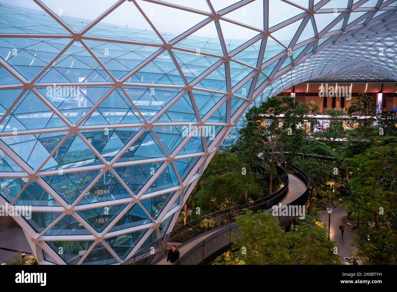 Massive glass dome and elevated walkway above indoor garden at the ...
