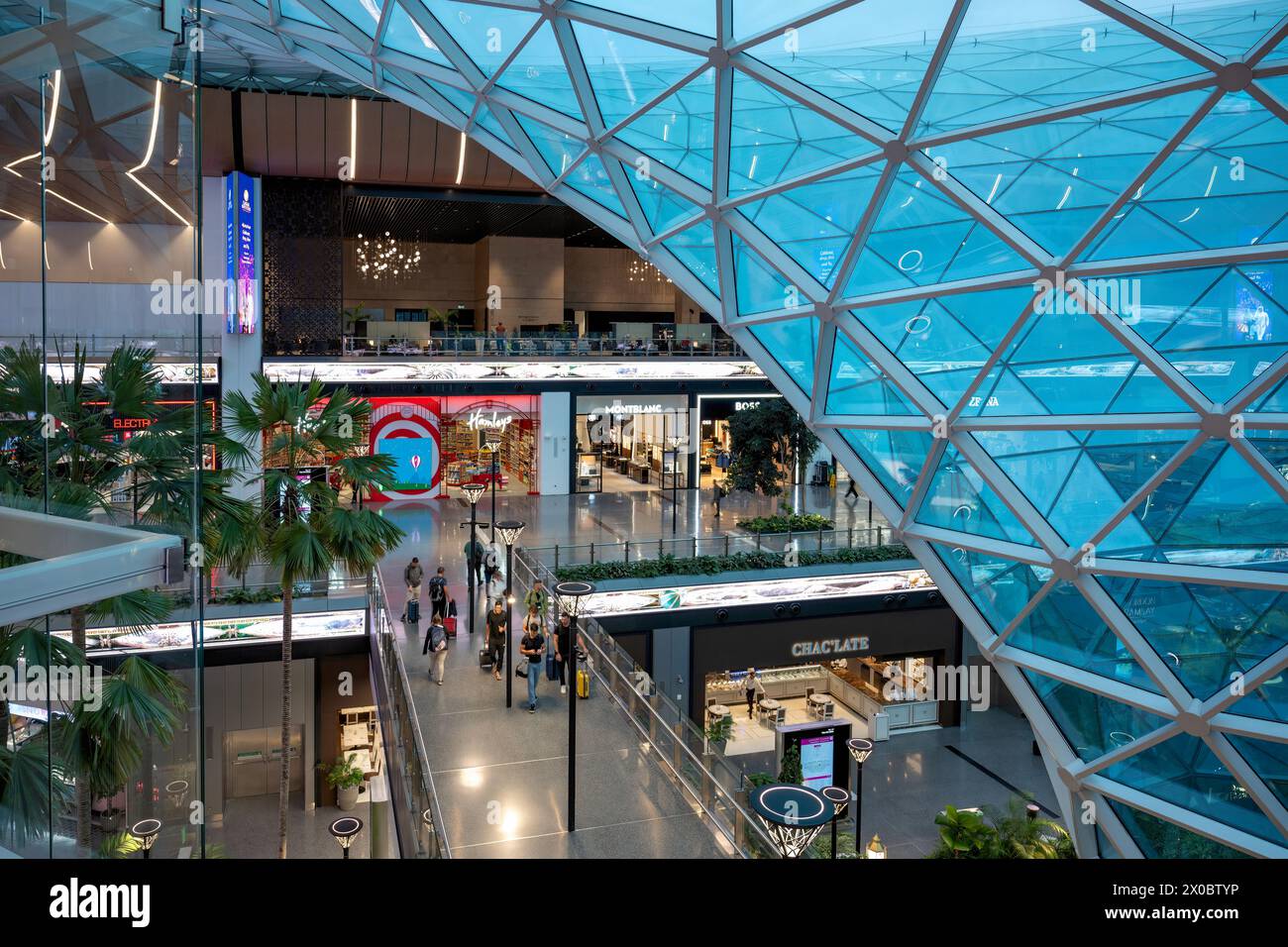 Massive glass dome and elevated walkway above indoor garden at the ...