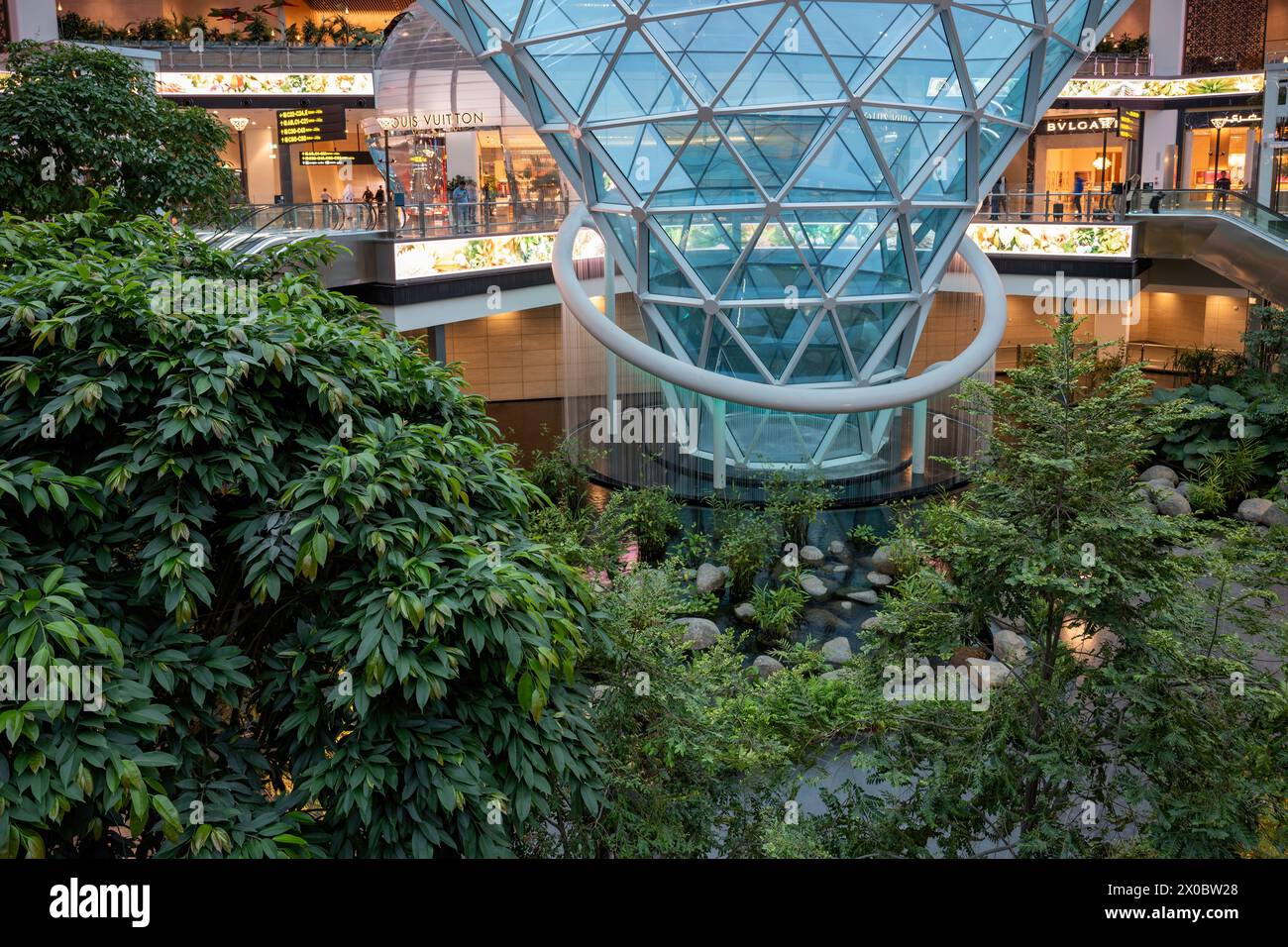 Massive glass dome and elevated walkway above indoor garden at the ...