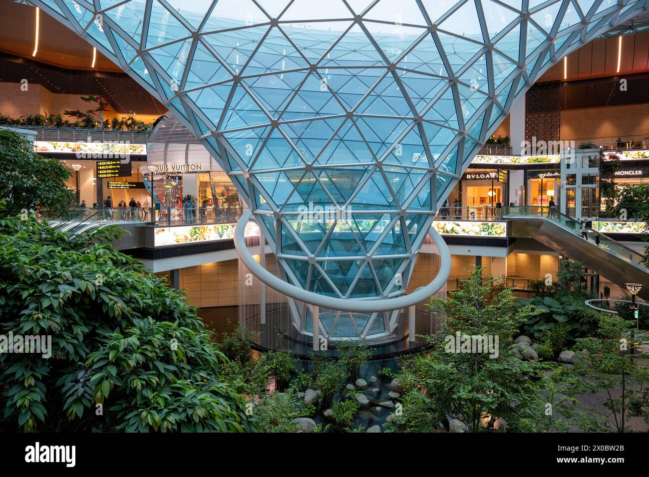 Massive glass dome and elevated walkway above indoor garden at the ...