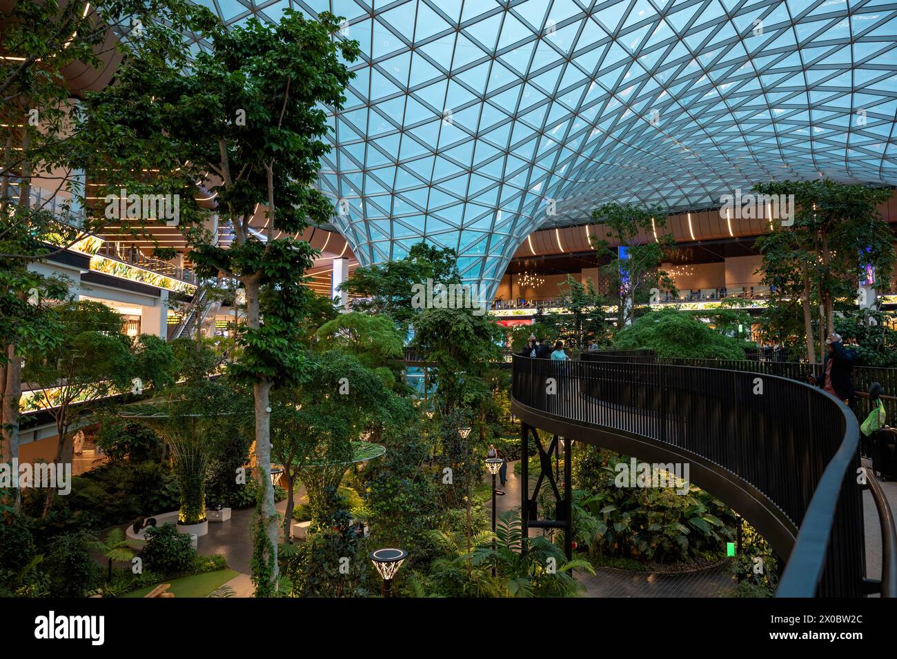 Massive glass dome and elevated walkway above indoor garden at the ...