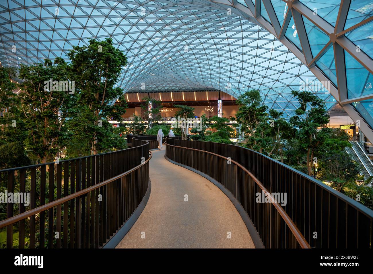 Massive glass dome and elevated walkway above indoor garden at the ...