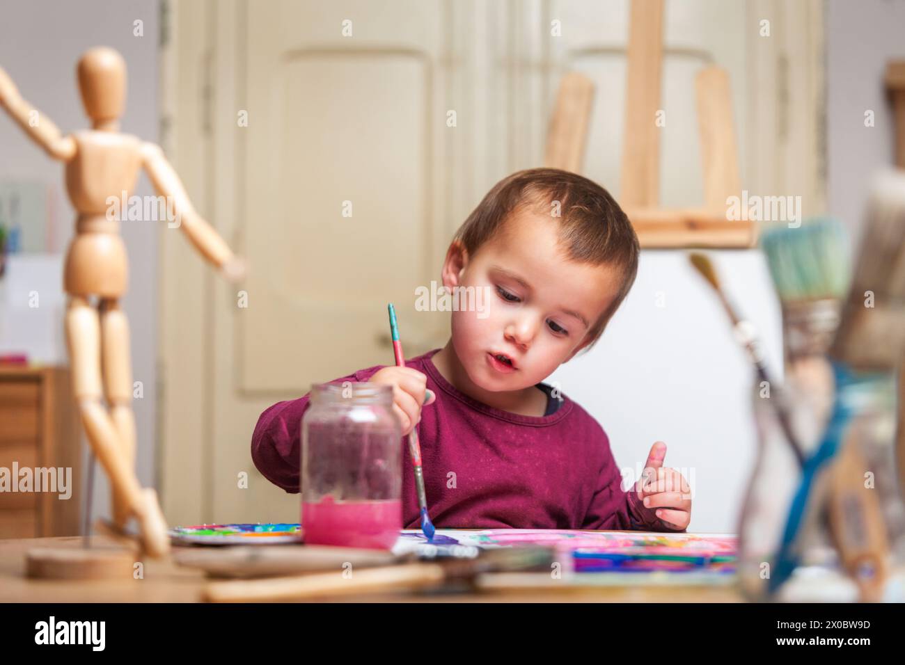 Young child enjoying his moment to develop his creativity during his ...