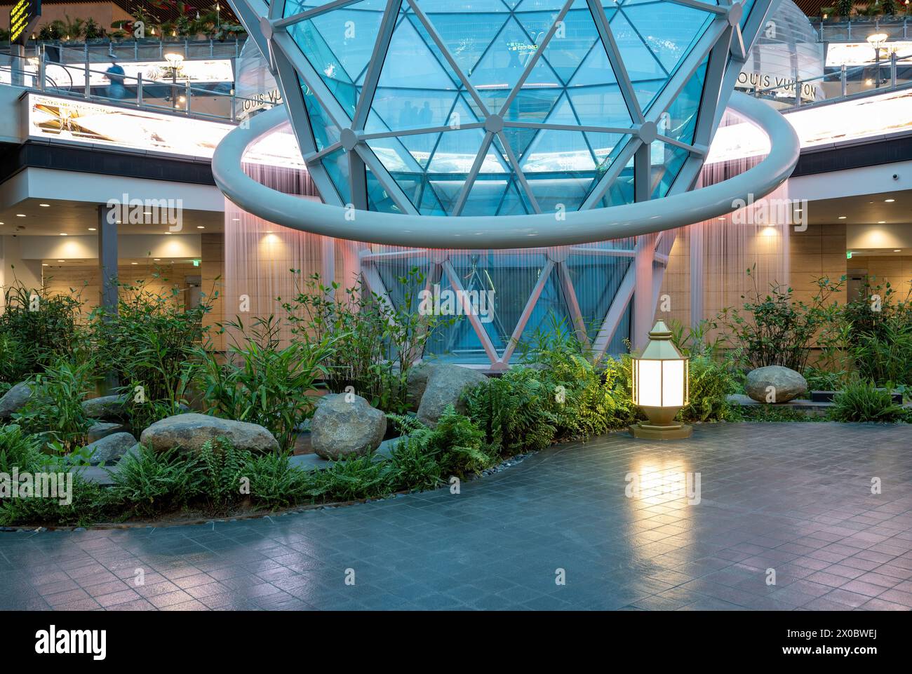 Massive glass dome and elevated walkway above indoor garden at the ...