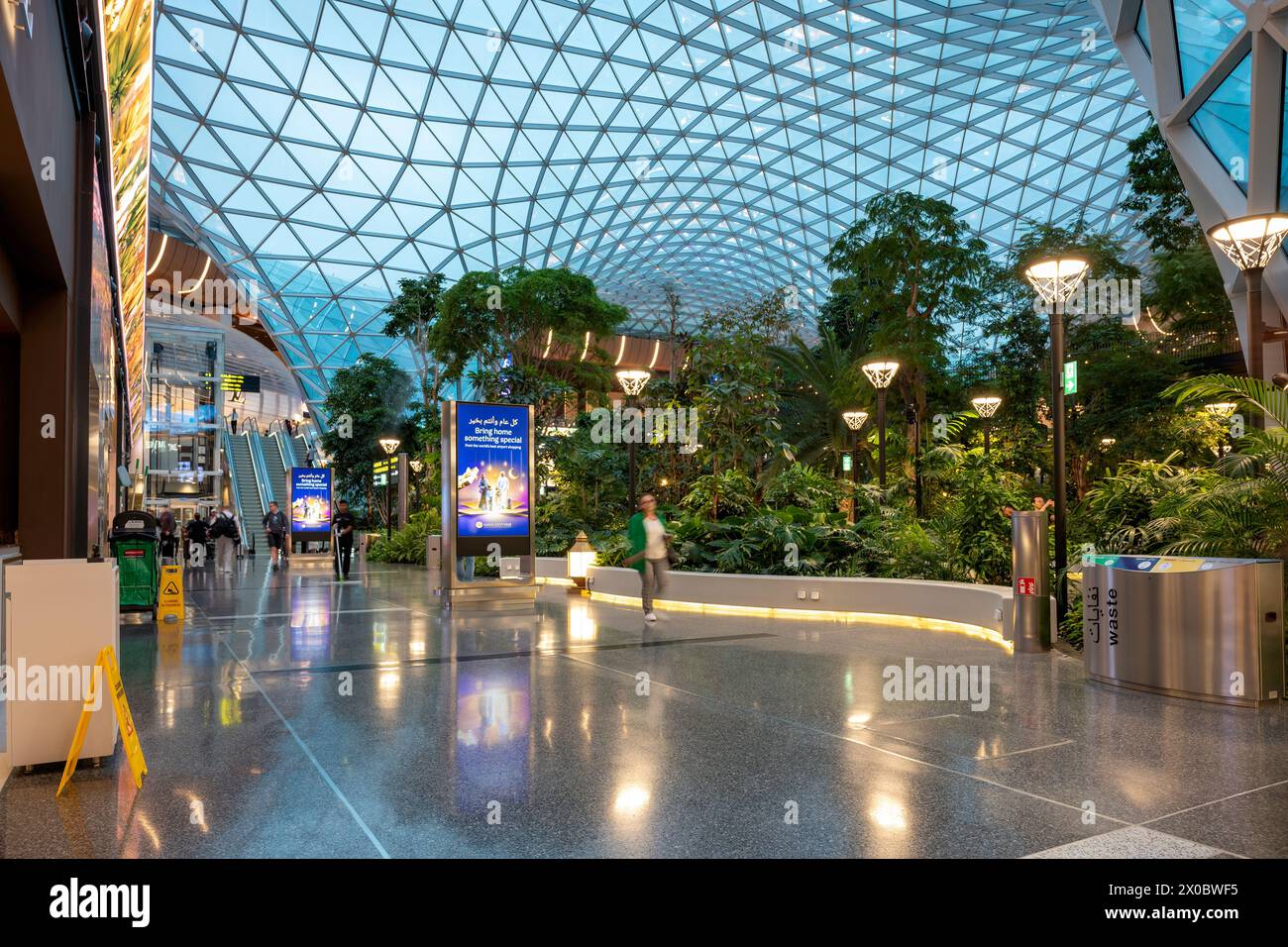 Massive glass dome and elevated walkway above indoor garden at the ...