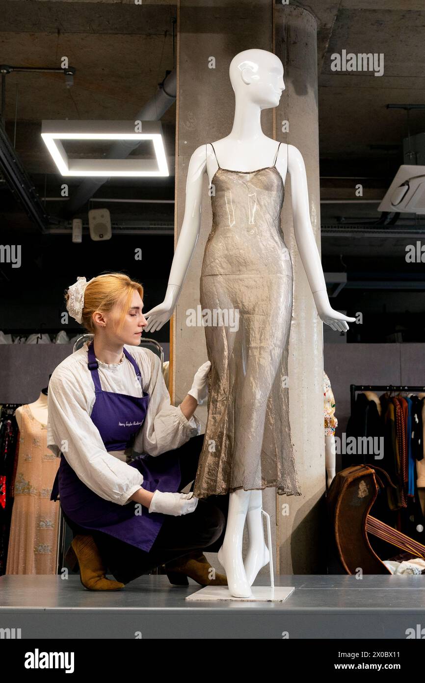 Julia Westerman, Cataloguer at Kerry Taylor Auctions handles a Liza Bruce lame slip dress ...