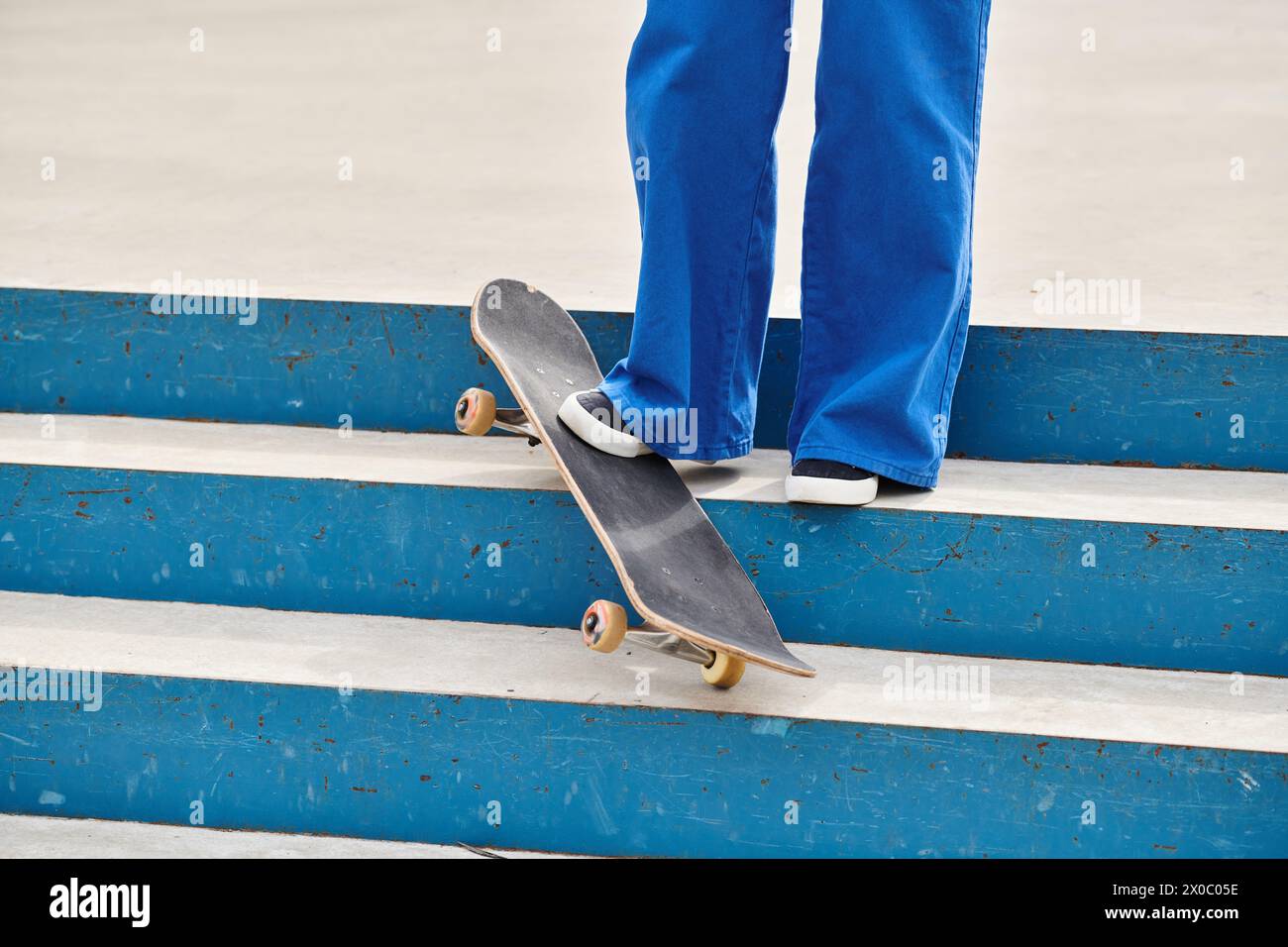 A young African American woman skillfully balances on a skateboard ...
