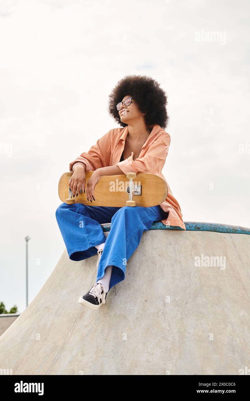 A young African American woman with curly hair sitting confidently on ...