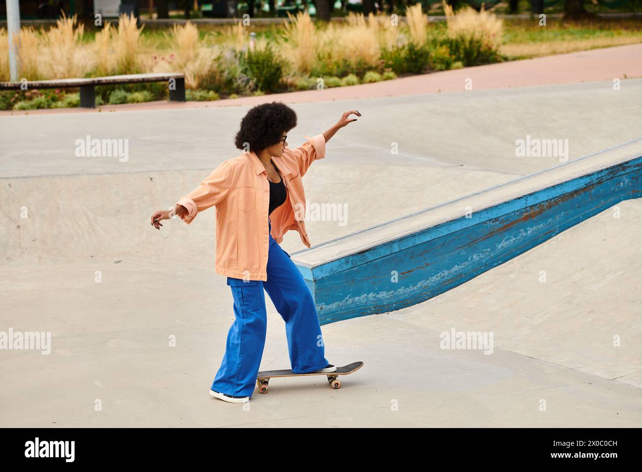 Young African American woman with curly hair confidently rides her ...