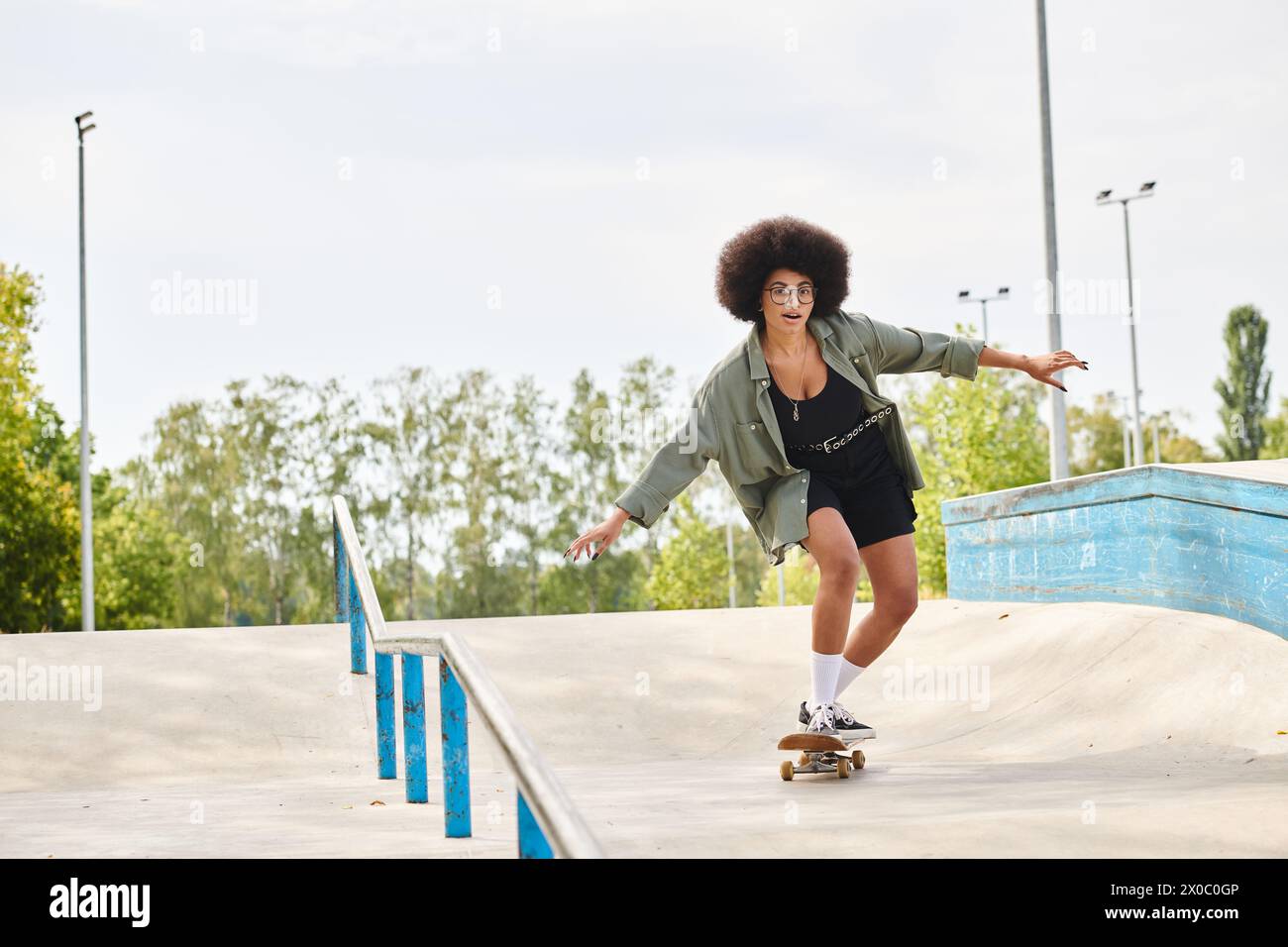 A young African American woman with curly hair confidently rides a ...