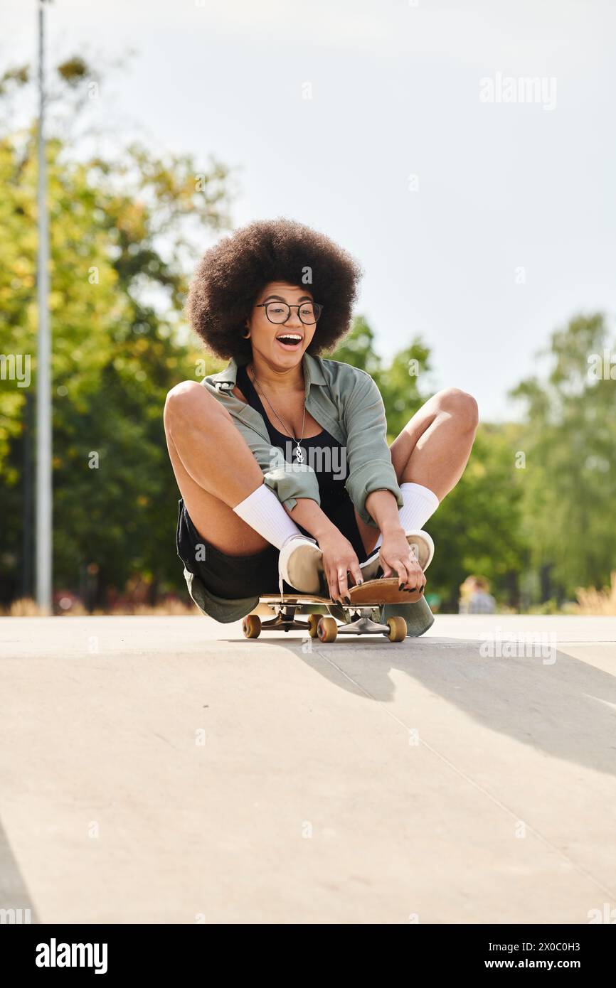 Young African American woman with curly hair confidently sits on top of ...