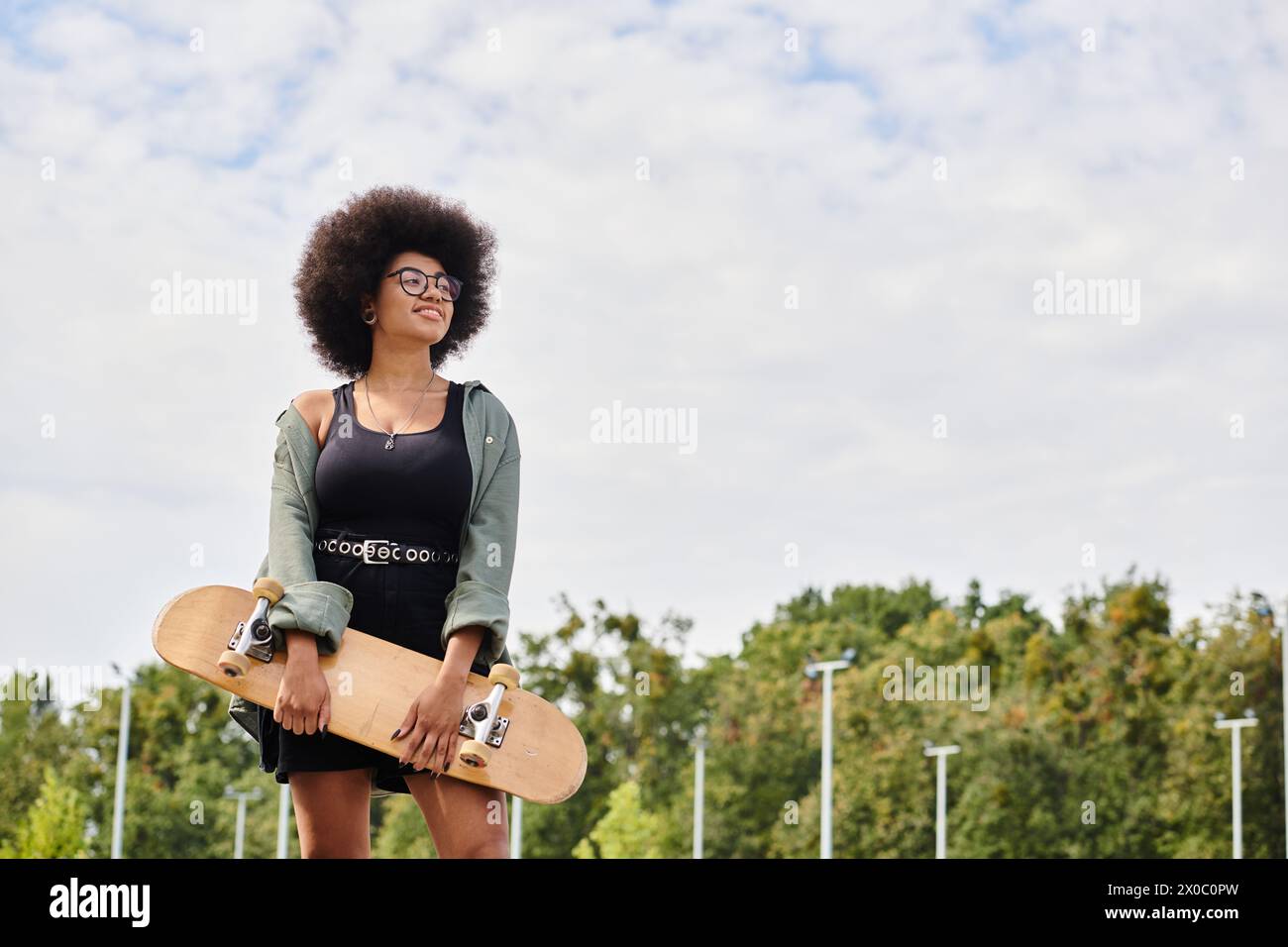 Energetic young African American woman with curly hair confidently ...