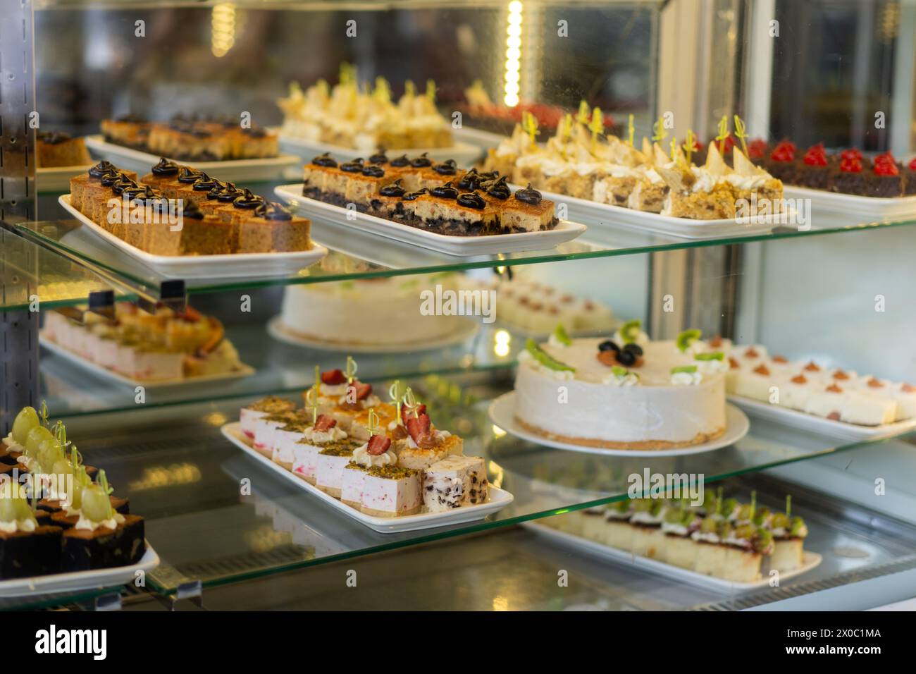 Showcase with sweets, Various desserts and cakes for sale in the pastry ...