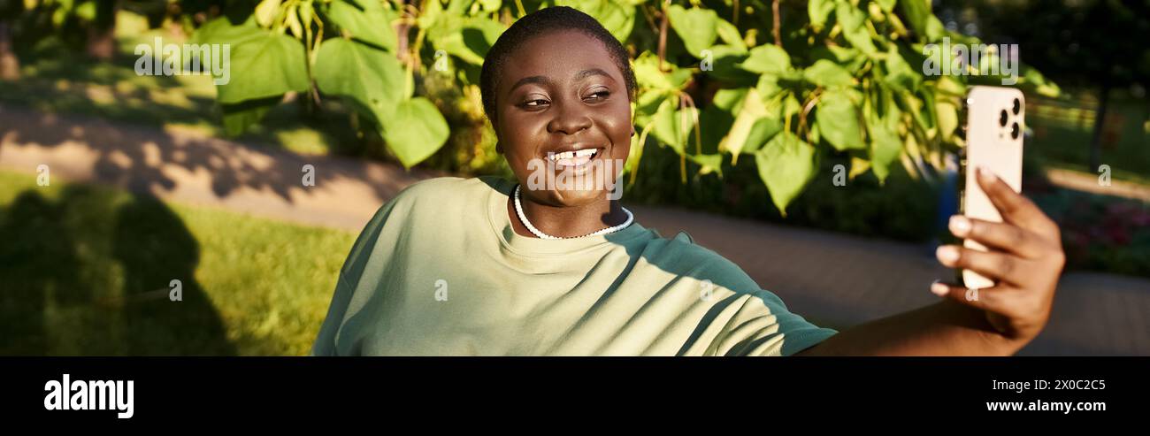 Plus-size African American woman captures a carefree moment, snapping a ...