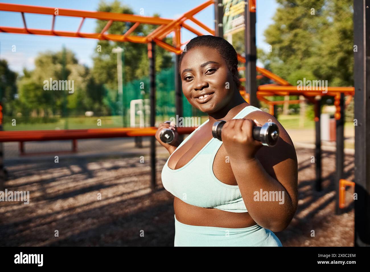 An African American woman in sportswear confidently exercises with a ...