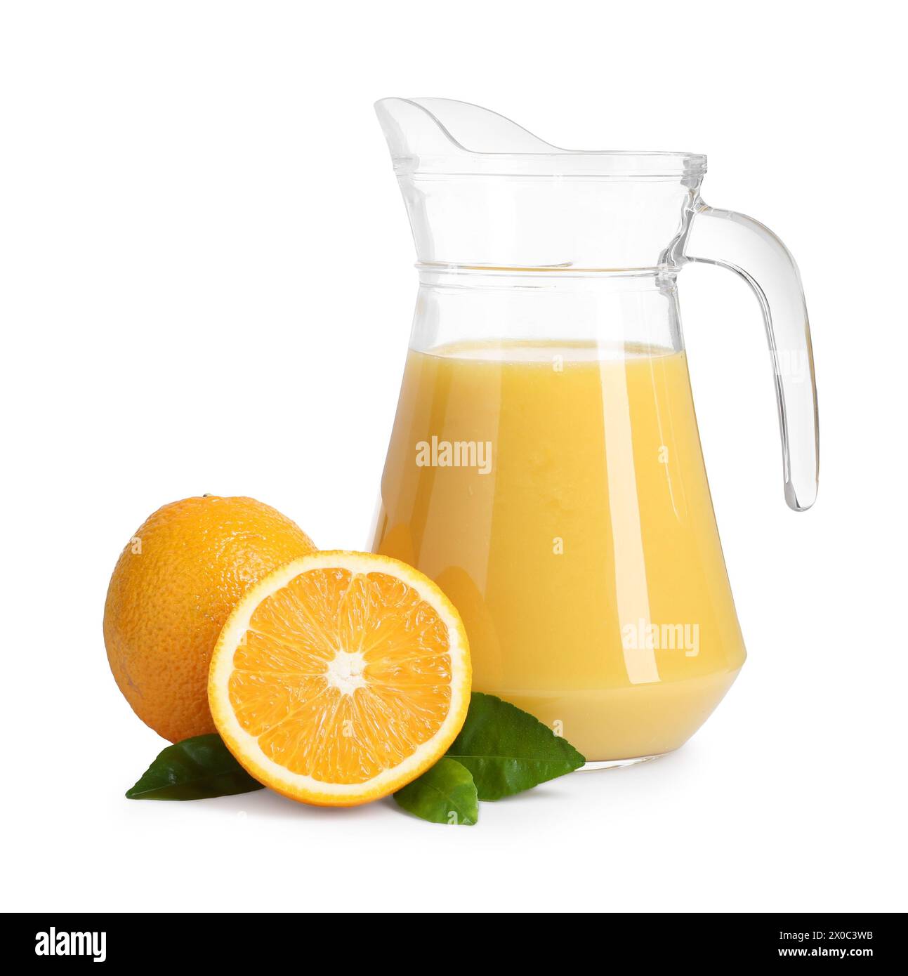 Refreshing orange juice in jug, leaves and fruits isolated on white ...