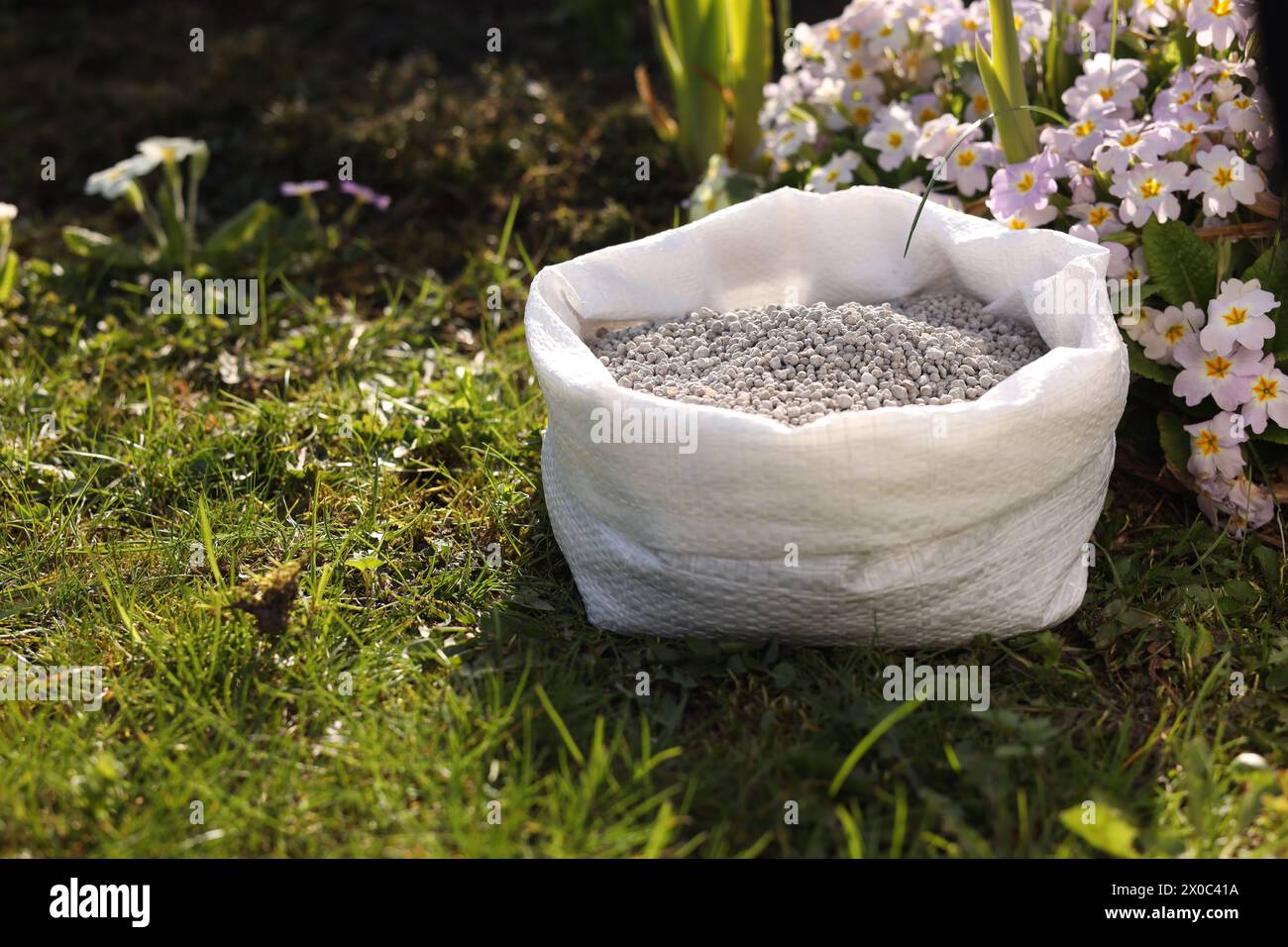 Fertilizer in bag on green grass outdoors Stock Photo - Alamy