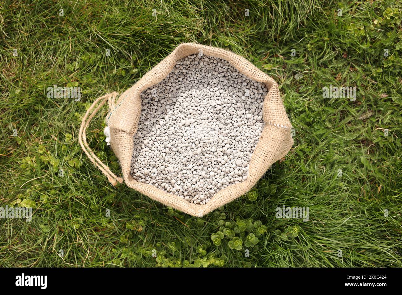 Fertilizer in bag on green grass outdoors, top view Stock Photo - Alamy