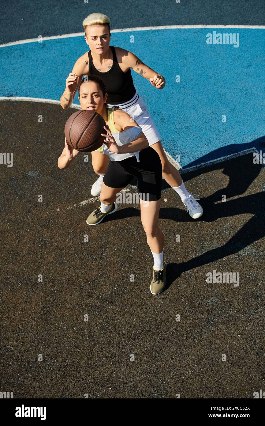 Two young women, athletic and competitive, engaging in a friendly game ...