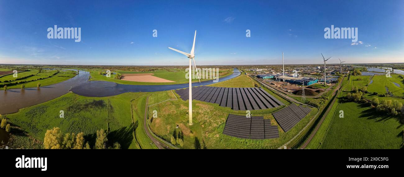Dutch landscape panorama of wind turbine and solar panels with waterway ...