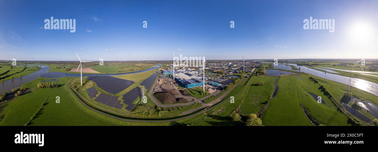Dutch landscape panorama of wind turbine and solar panels with waterway ...