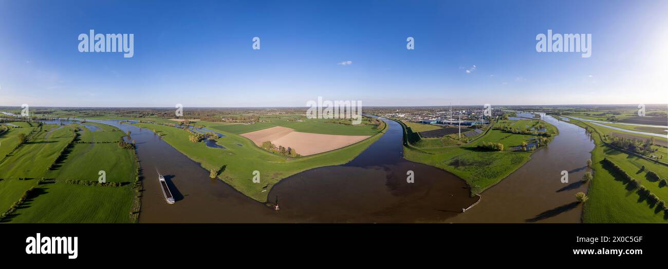 Dutch landscape panorama of wind turbine and solar panels with waterway ...