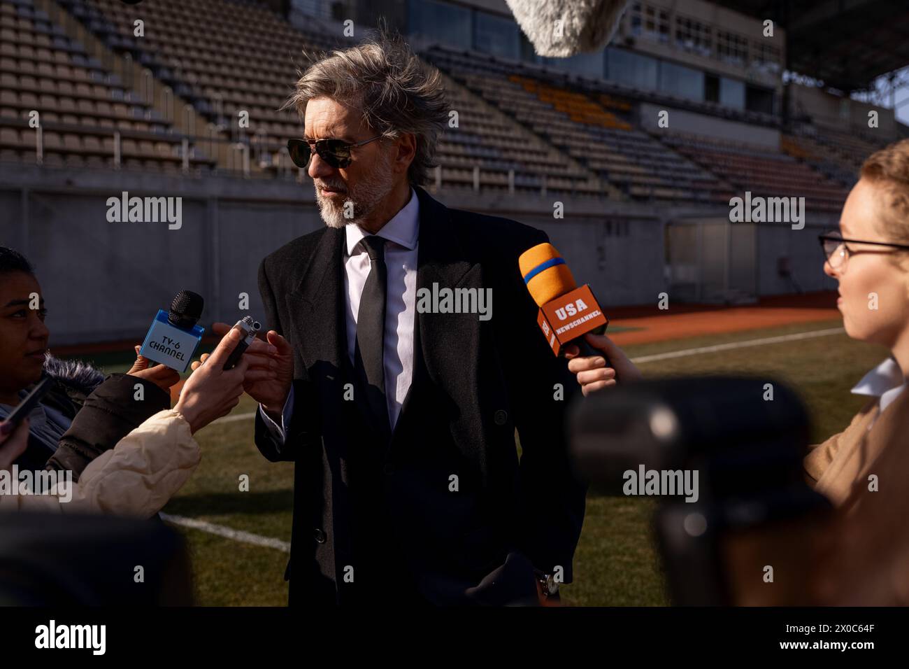 Interview of football team director at press conference for TV news ...