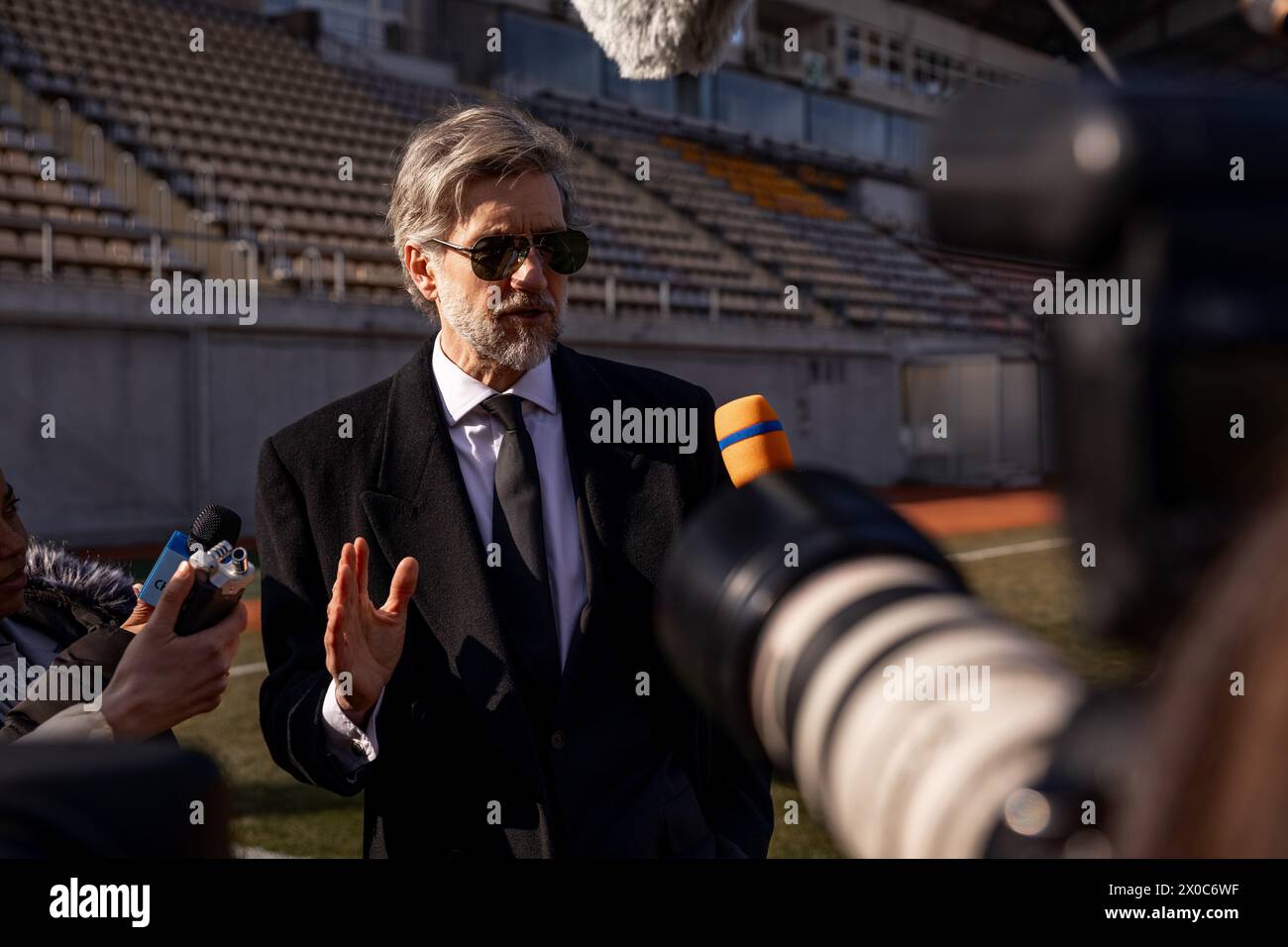 Interview of football team director at press conference for TV news ...