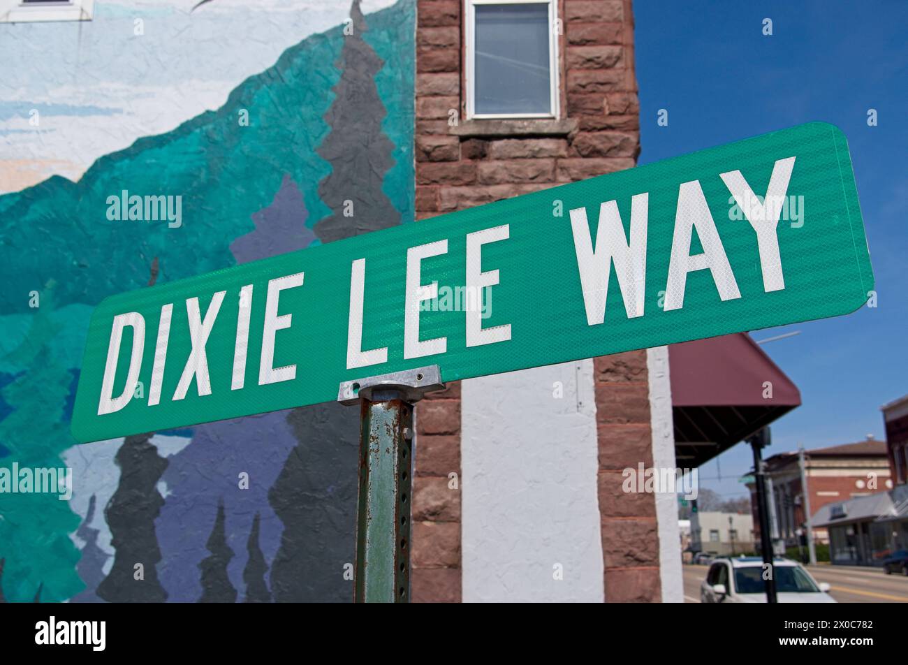 White and green street sign with stone and concrete wall background ...