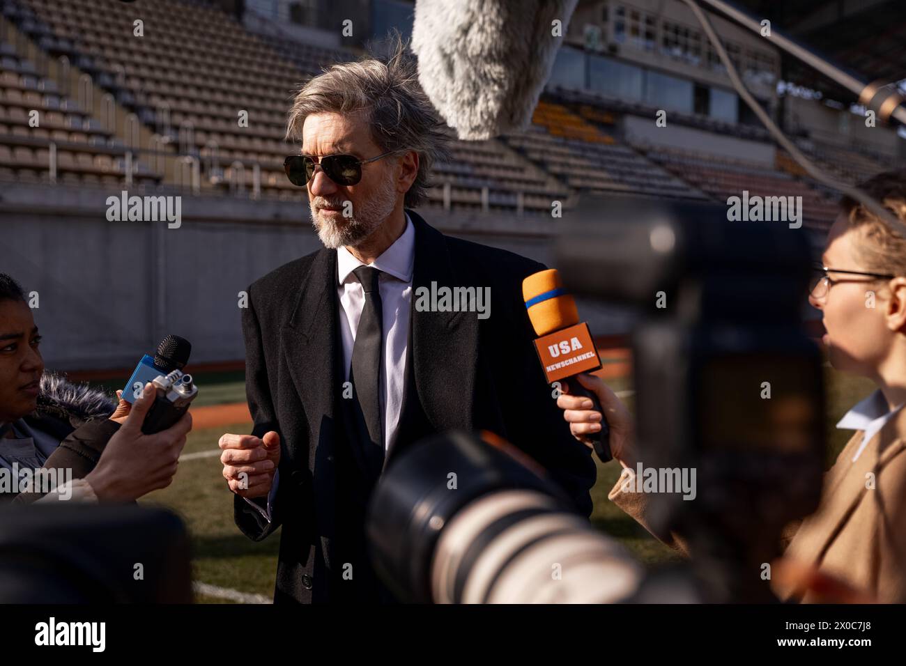 Interview of football team director at press conference for TV news ...