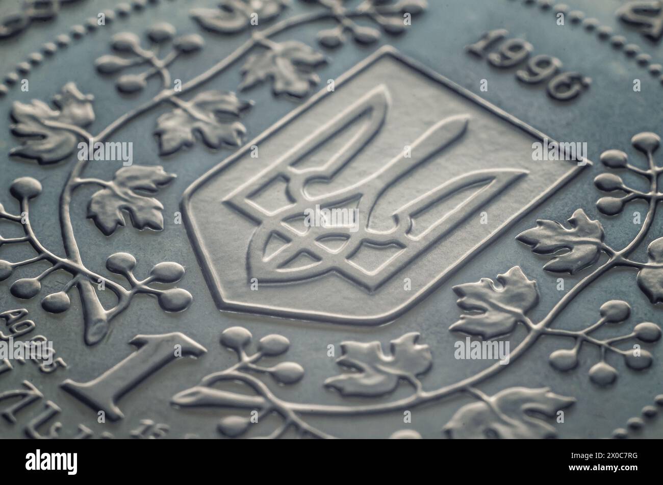 Macro photo of a Ukrainian coin. Ukrainian coat of arms trident on a ...