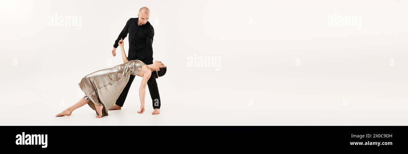 A young man in black and a young woman in a shiny dress perform ...