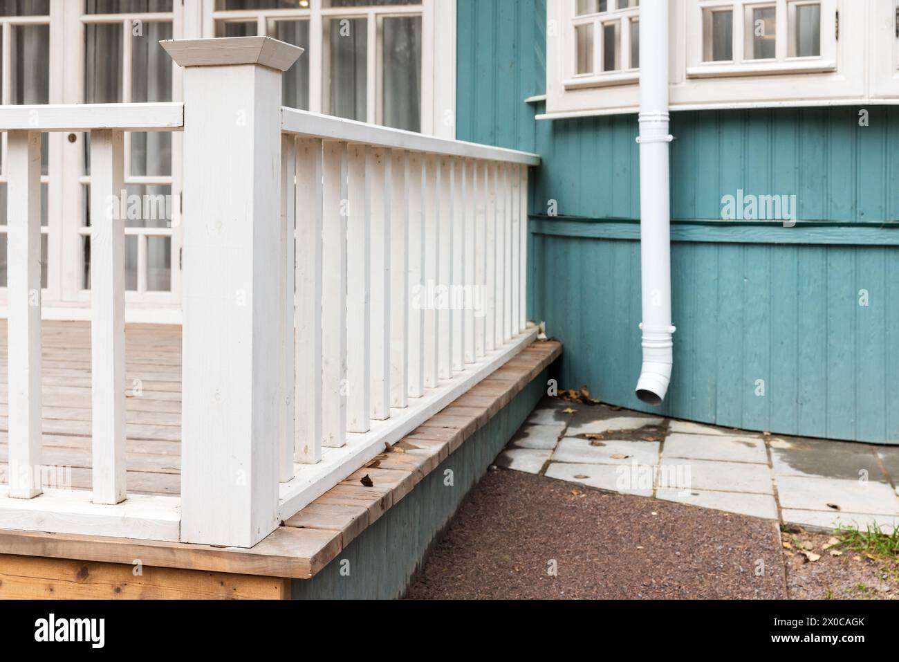 Rural wooden house exterior details, white terrace railings and blue ...