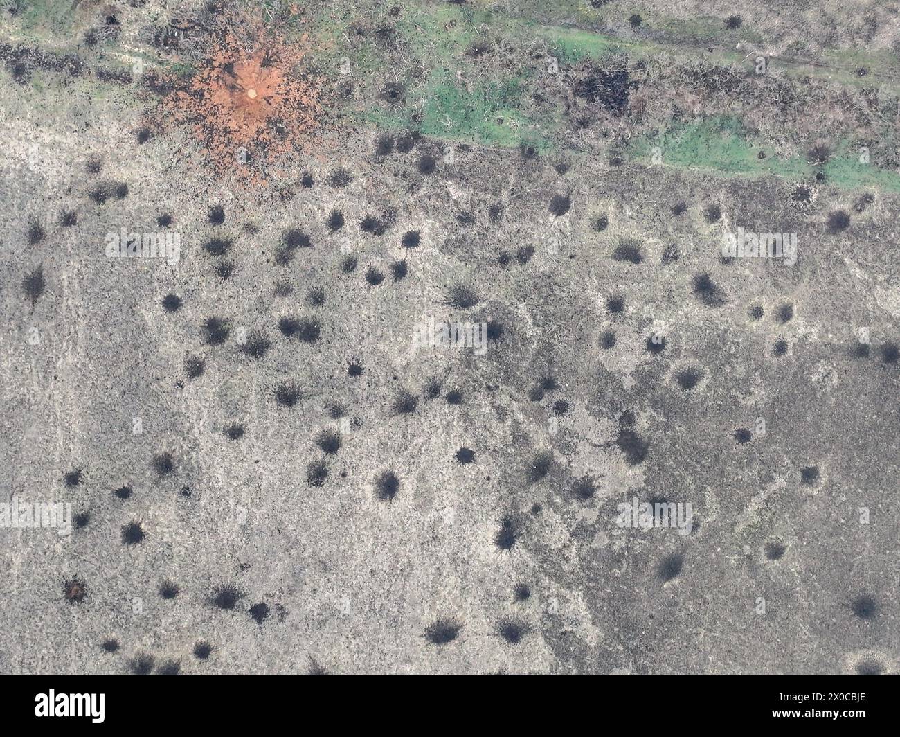 Funnels from artillery explosions cannon shells on the ground: top view ...