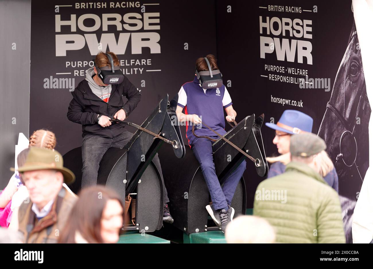 Racegoers take part in a vr horse racing experience on day one of the ...