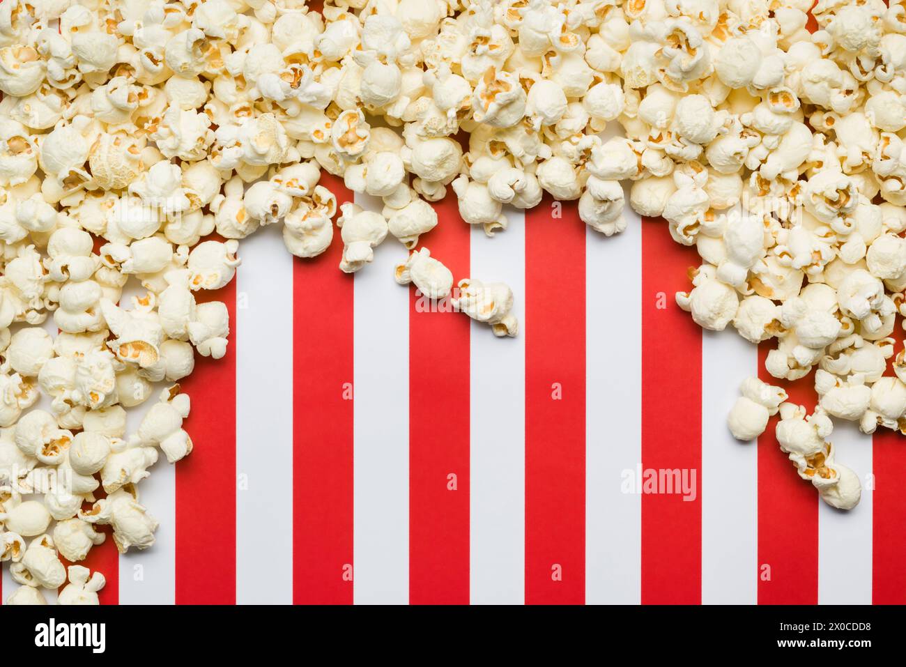 Flat lay composition with popcorn border and copy space on red and ...