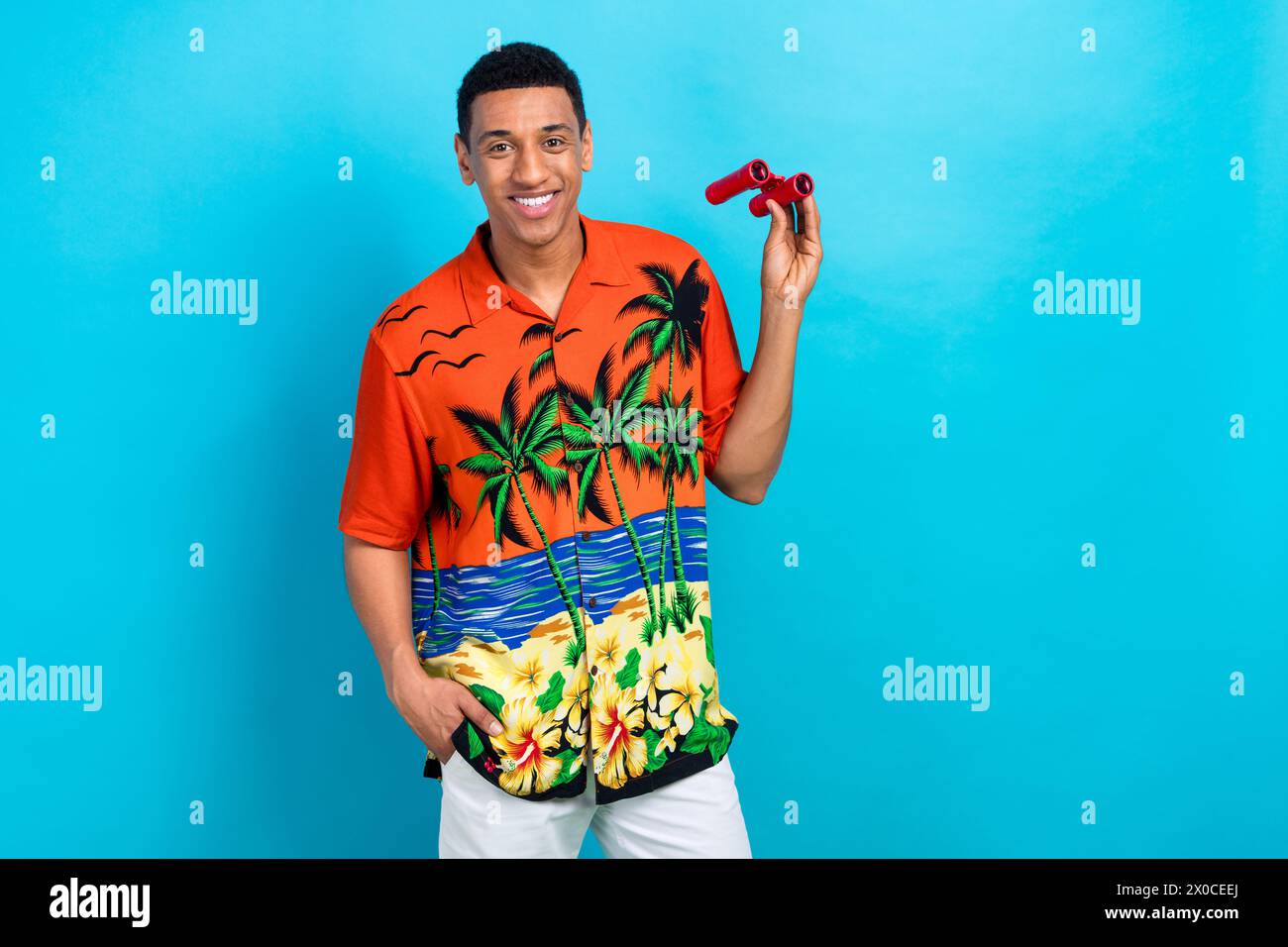 Photo of positive cheerful guy dressed print shirt holding binoculars ...