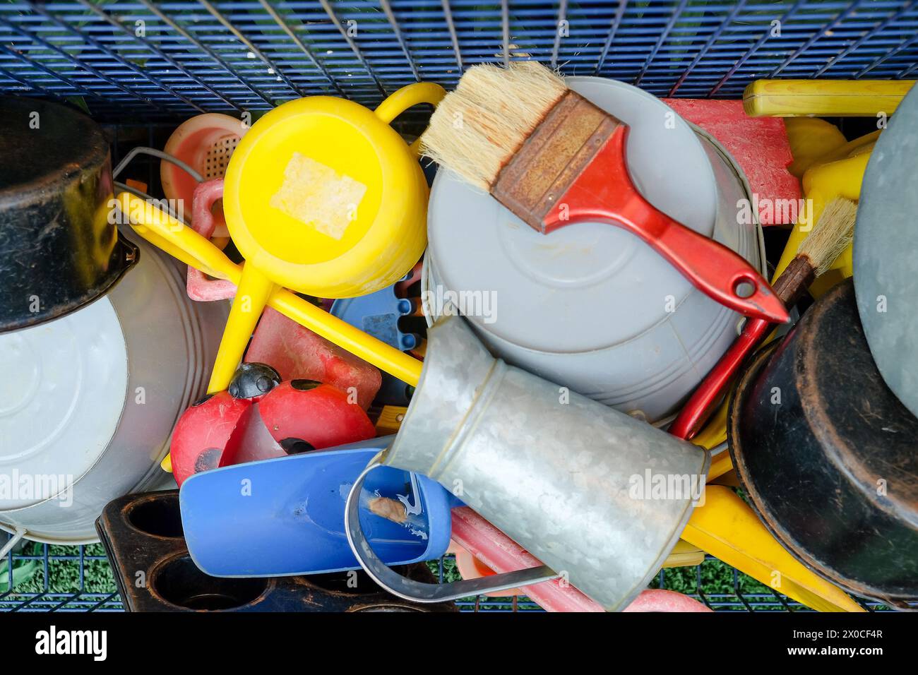 Colorful array of common household items and tools in a disorganized ...