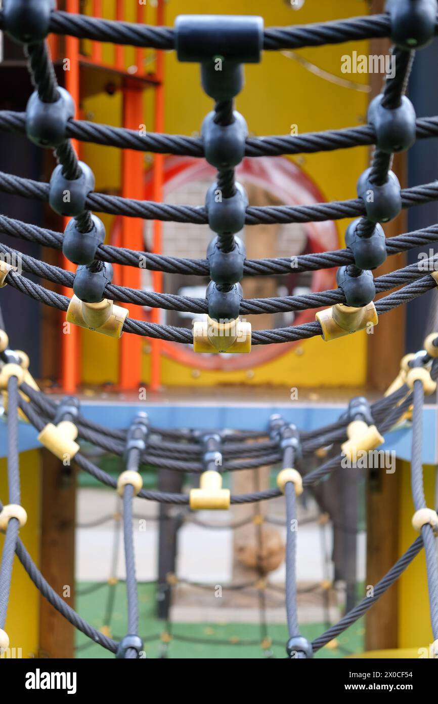 Close-up view of colorful playground rope bridge for children's outdoor ...
