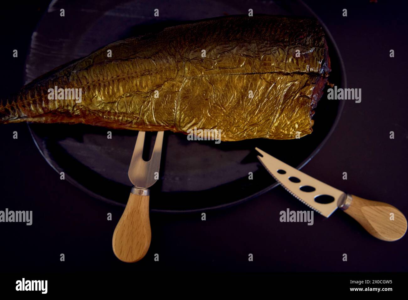 process of dissecting hot smoked golden horse mackerel with small ...