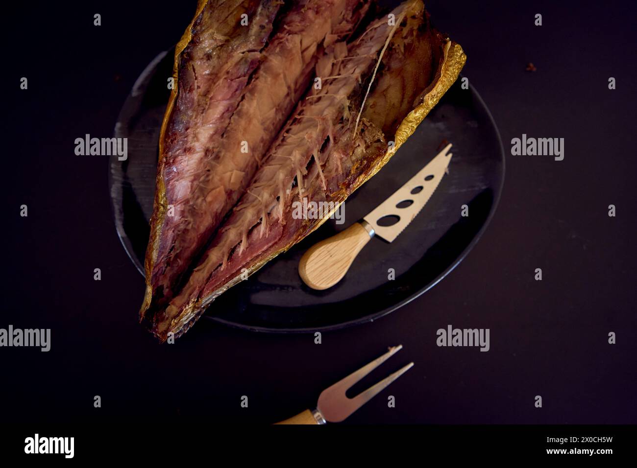 process of dissecting hot smoked golden horse mackerel with small ...